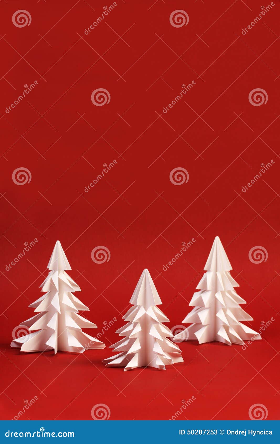 Three White Paper Trees on Red Background - Vertical Stock Image ...