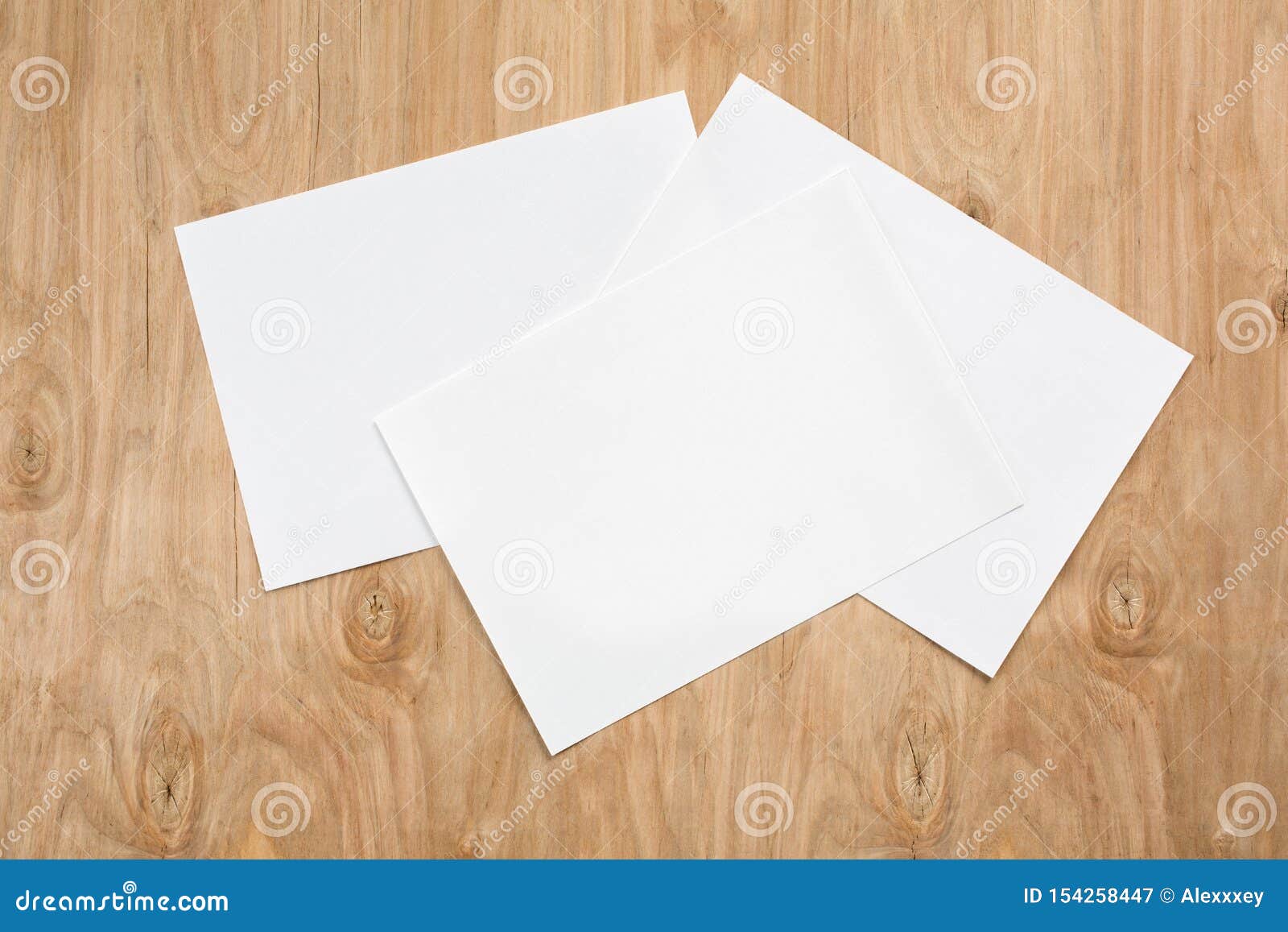 Three White Sheets of Paper on a Wooden Background Stock Image - Image ...
