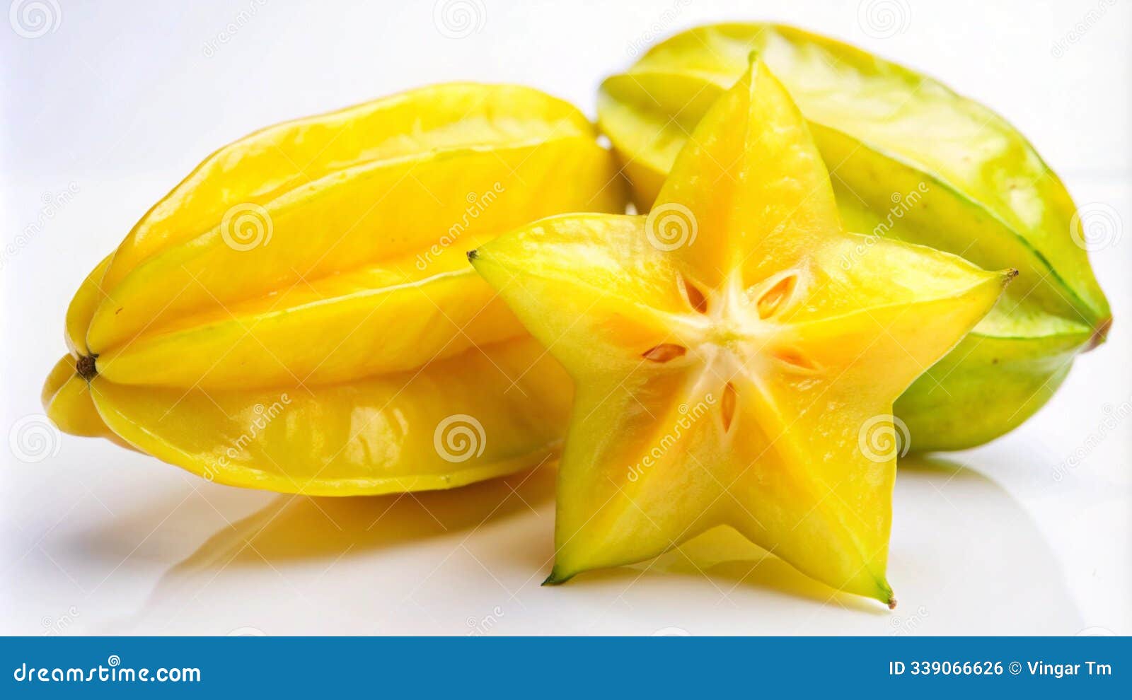 Three Whole and One Sliced Starfruit on a White Background Stock ...