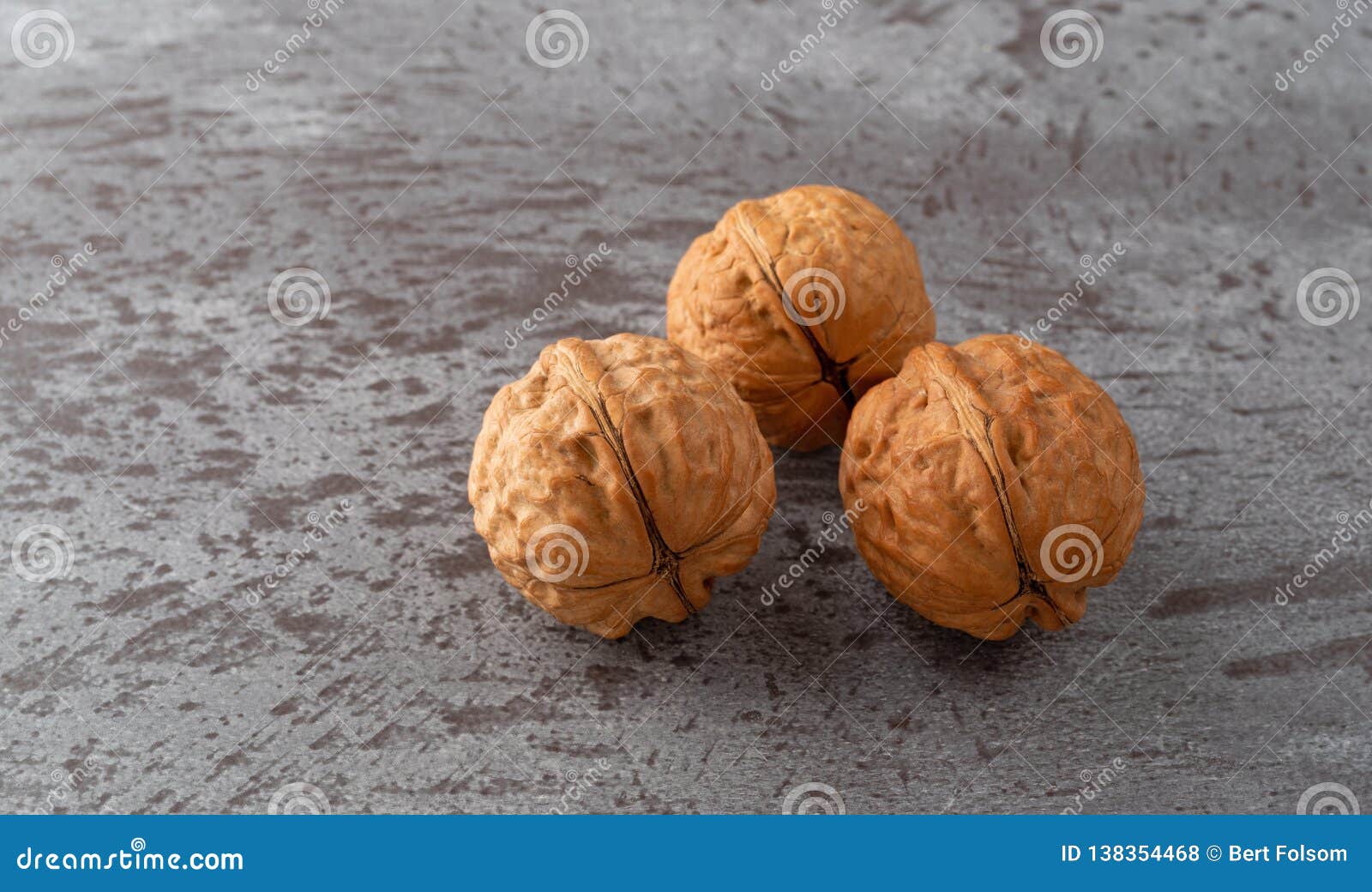 Three Whole Walnuts on a Gray Background Stock Photo - Image of snack ...