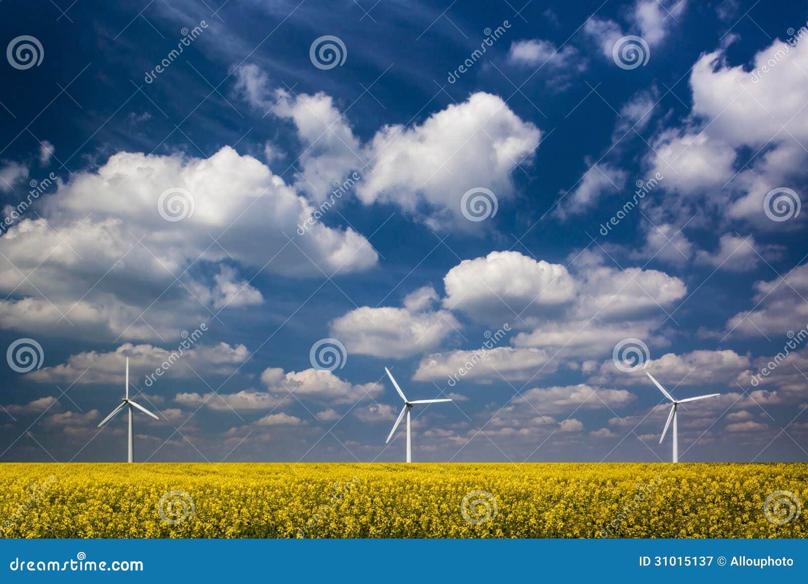 Three Wind Turbines Under a Blue, Cloud-strewn Sky Stock Image - Image ...