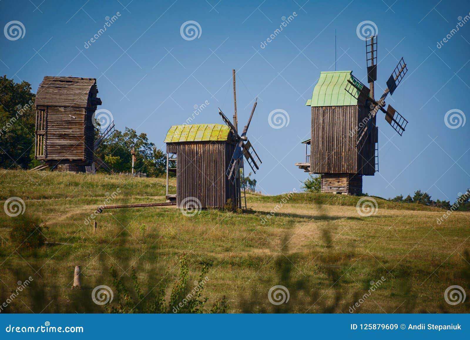 Three windmills on a hill stock image. Image of summer - 125879609