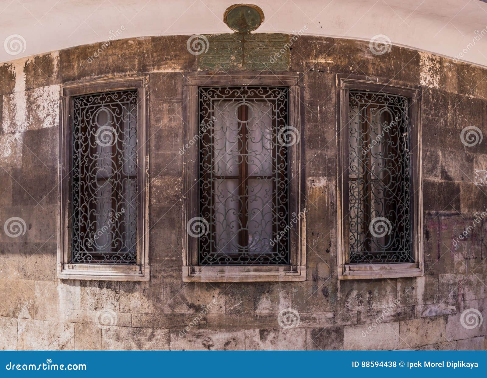 Three Windows with Ornamented Metal Lattice on a Stone Building Stock ...