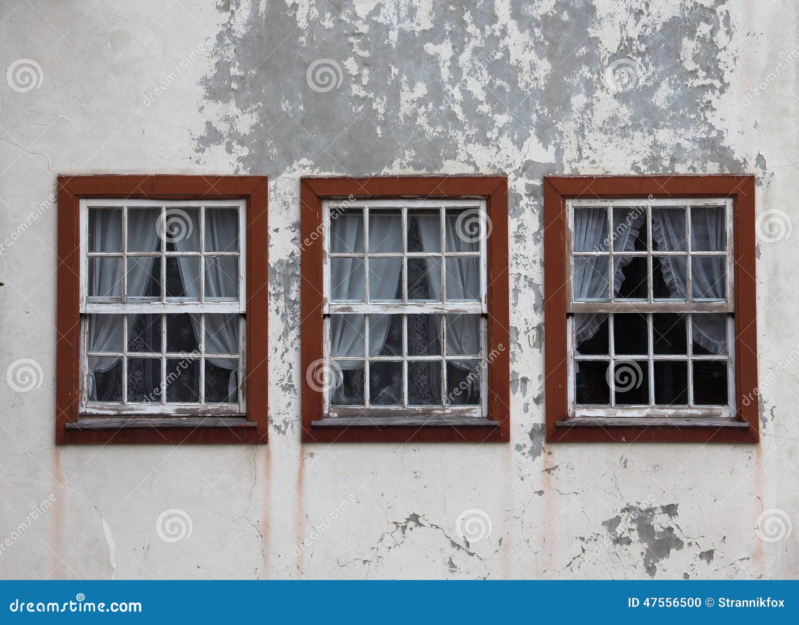 Three Windows on the Shabby Wall Closed with Curtains Stock Photo ...