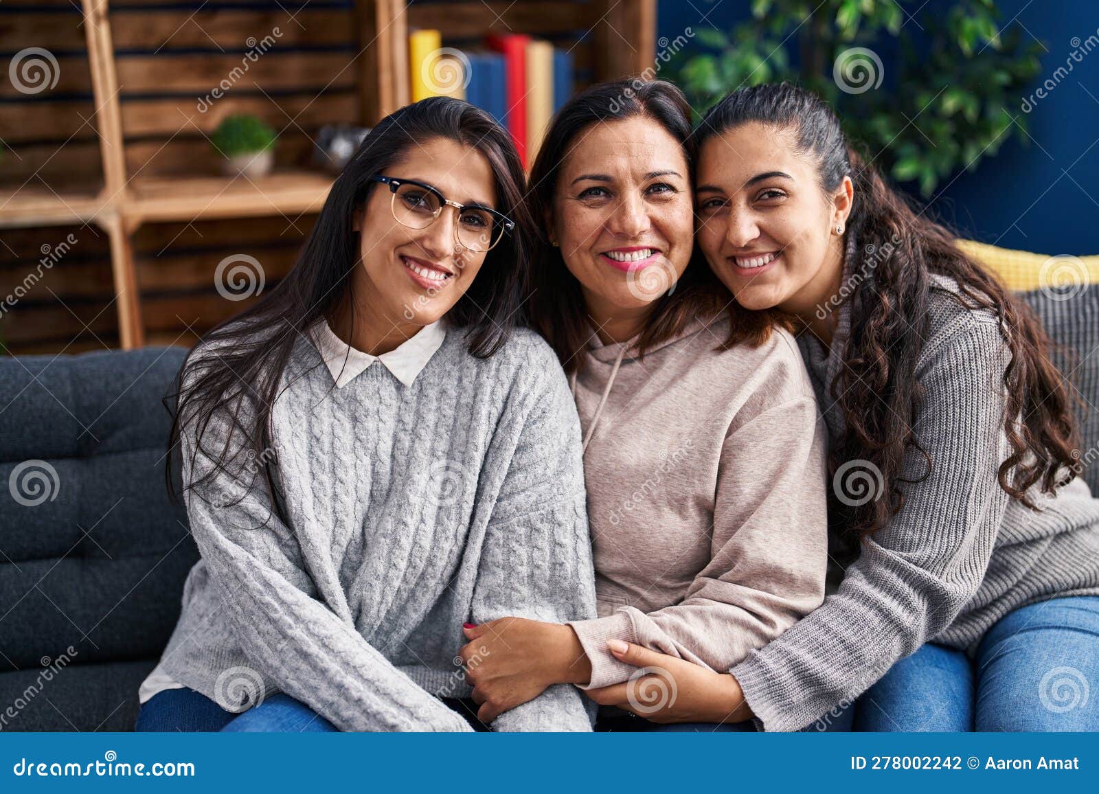 Three Woman Hugging Each Other Sitting on Sofa at Home Stock Photo ...