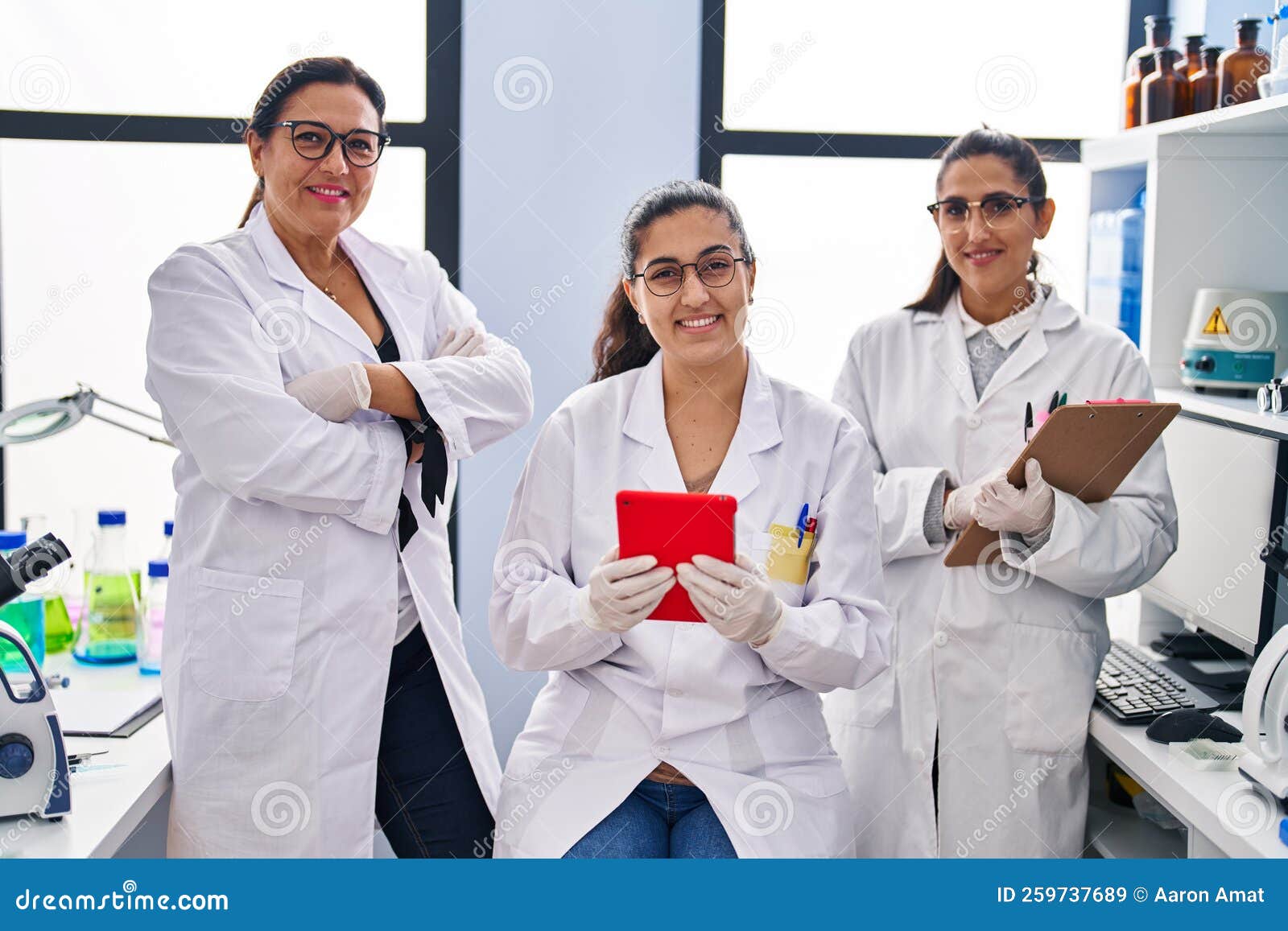 Three Woman Scientists Using Touchpad Write On Checklist At Laboratory ...