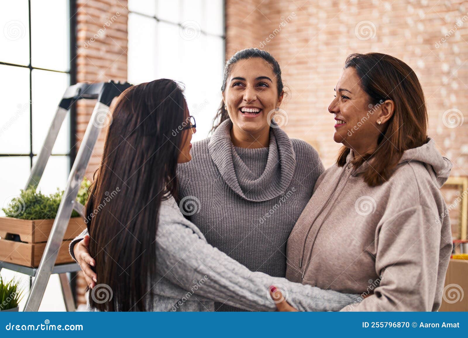Three Woman Smiling Confident Hugging Each Other at New Home Stock ...