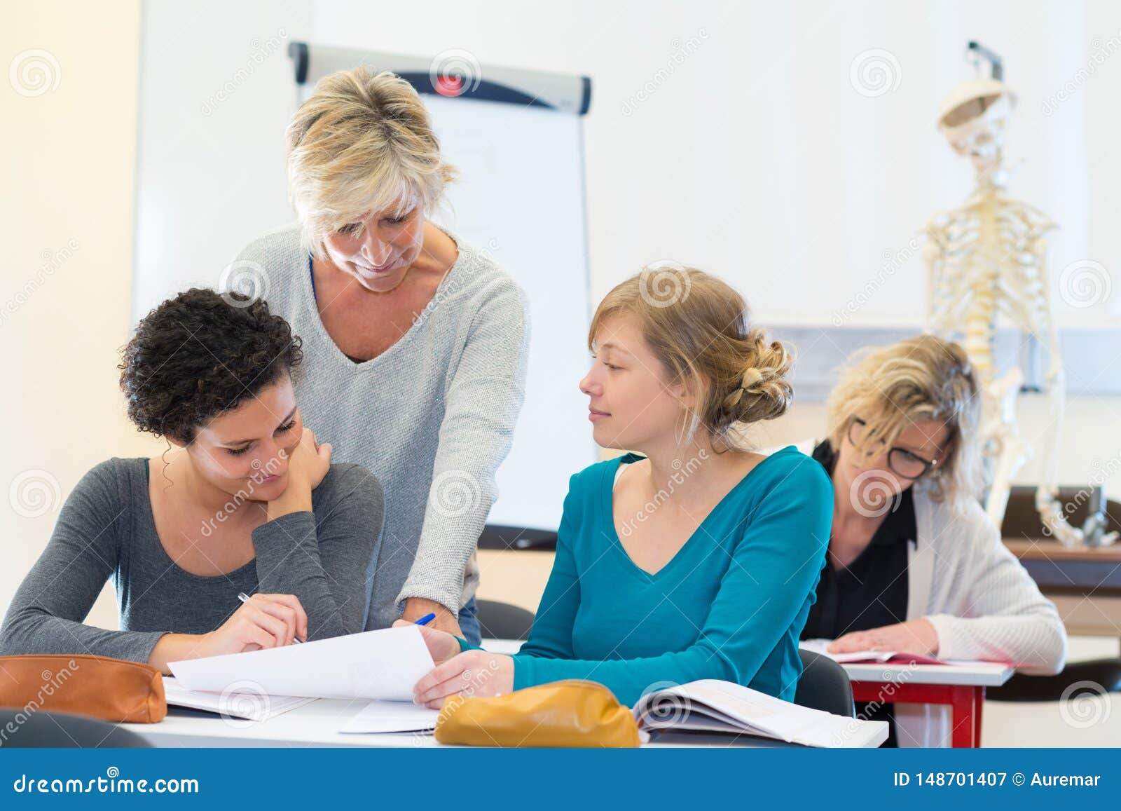 Three Women in Classroom with Teacher Stock Image - Image of holding ...