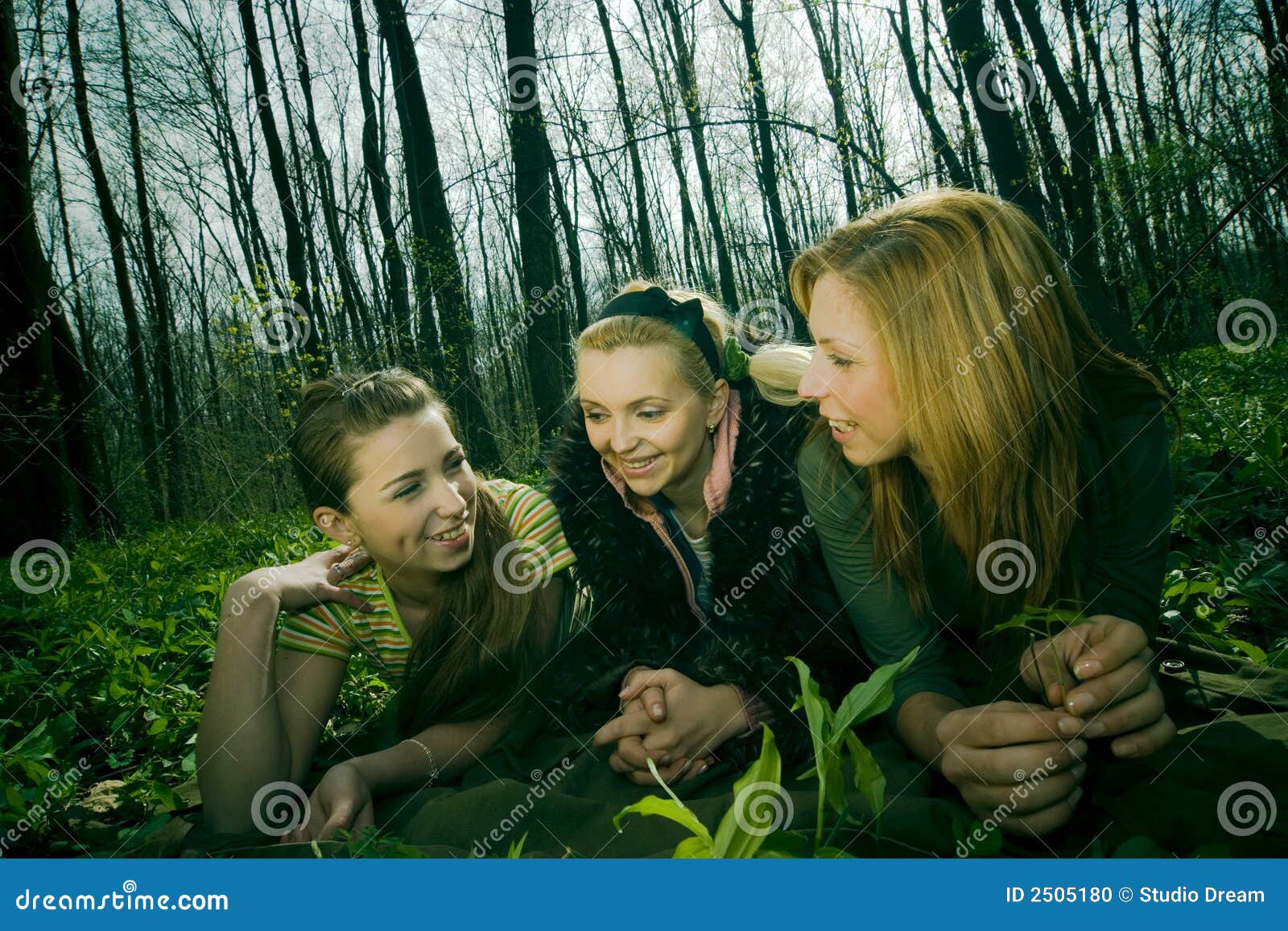 Three Women in Forest Clearing Stock Photo - Image of freshness ...