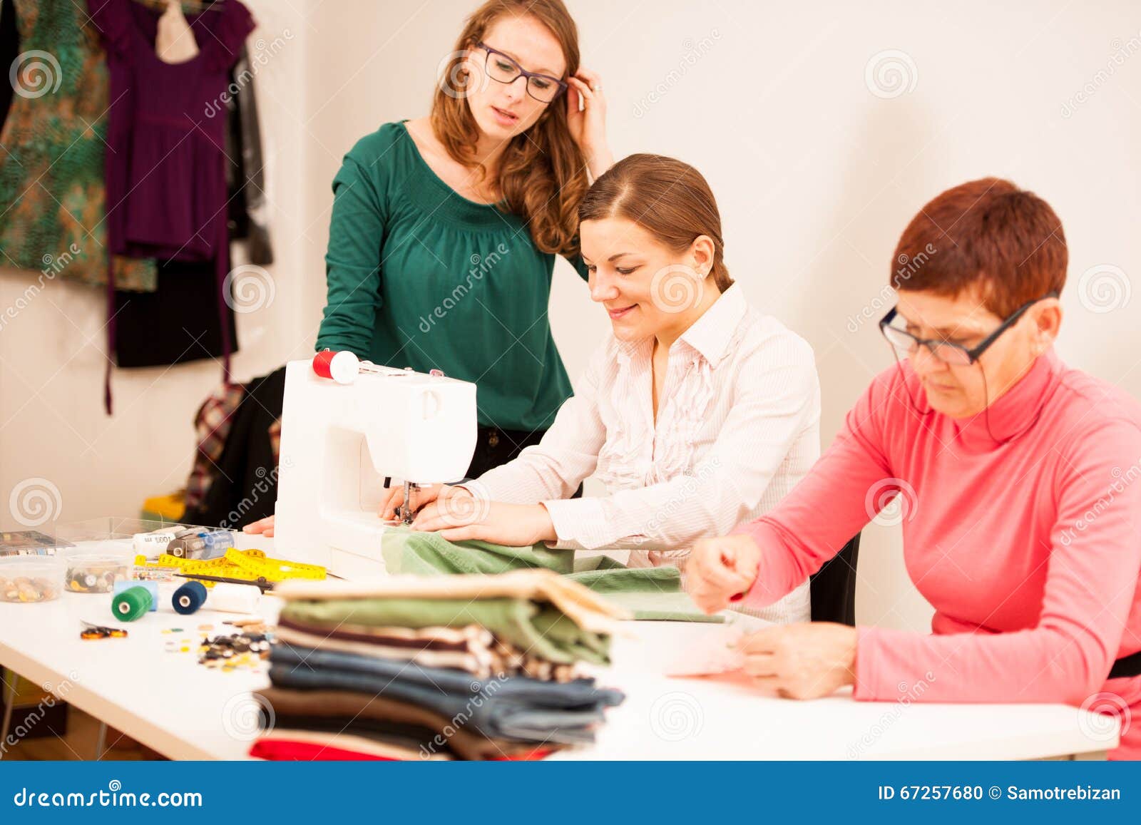 Three Women are Sewing on Handcraft Workshop. they are Teaching Stock ...