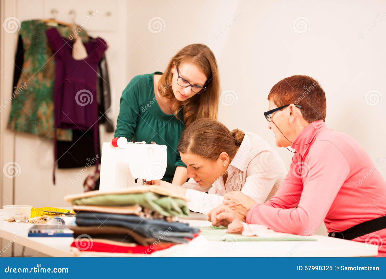 Three Women are Sewing on Handcraft Workshop. they are Teaching Stock ...