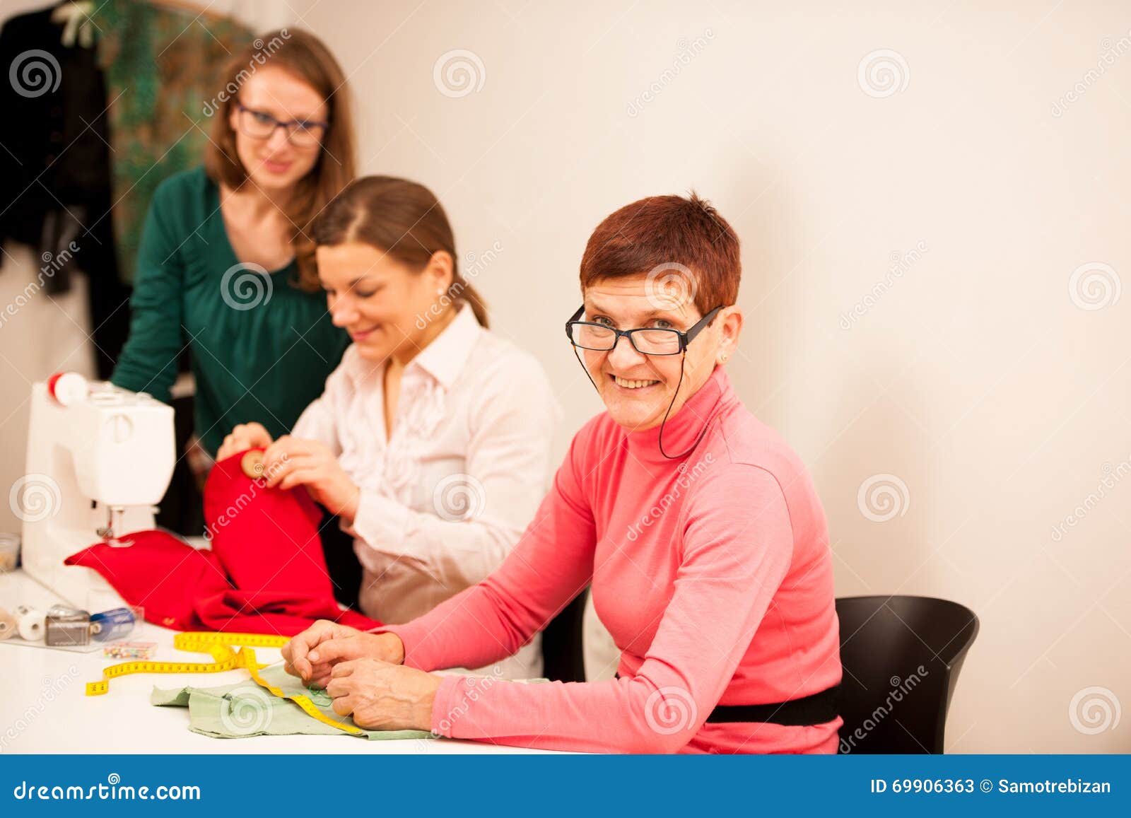 Three Women are Sewing on Handcraft Workshop. they are Teaching Stock ...