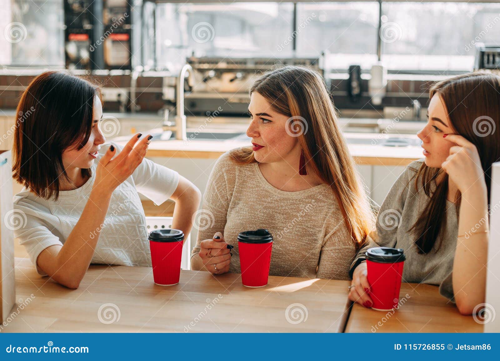 Three Women Sitting At Cafe Talking Stock Image Image Of Mall