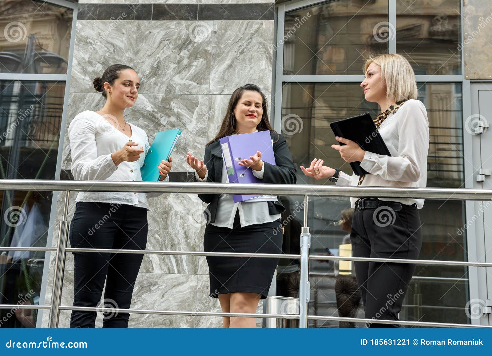 Three Women in Teamwork. they Holding Folders and Discussing ...