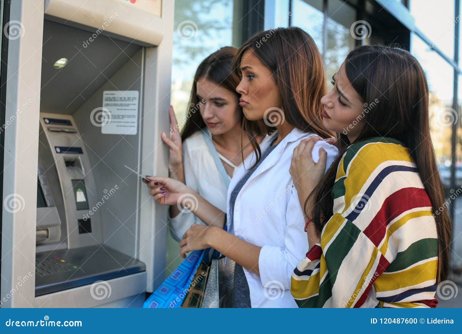 Three Women Using ATM Machine. Stock Photo - Image of machine, outside ...