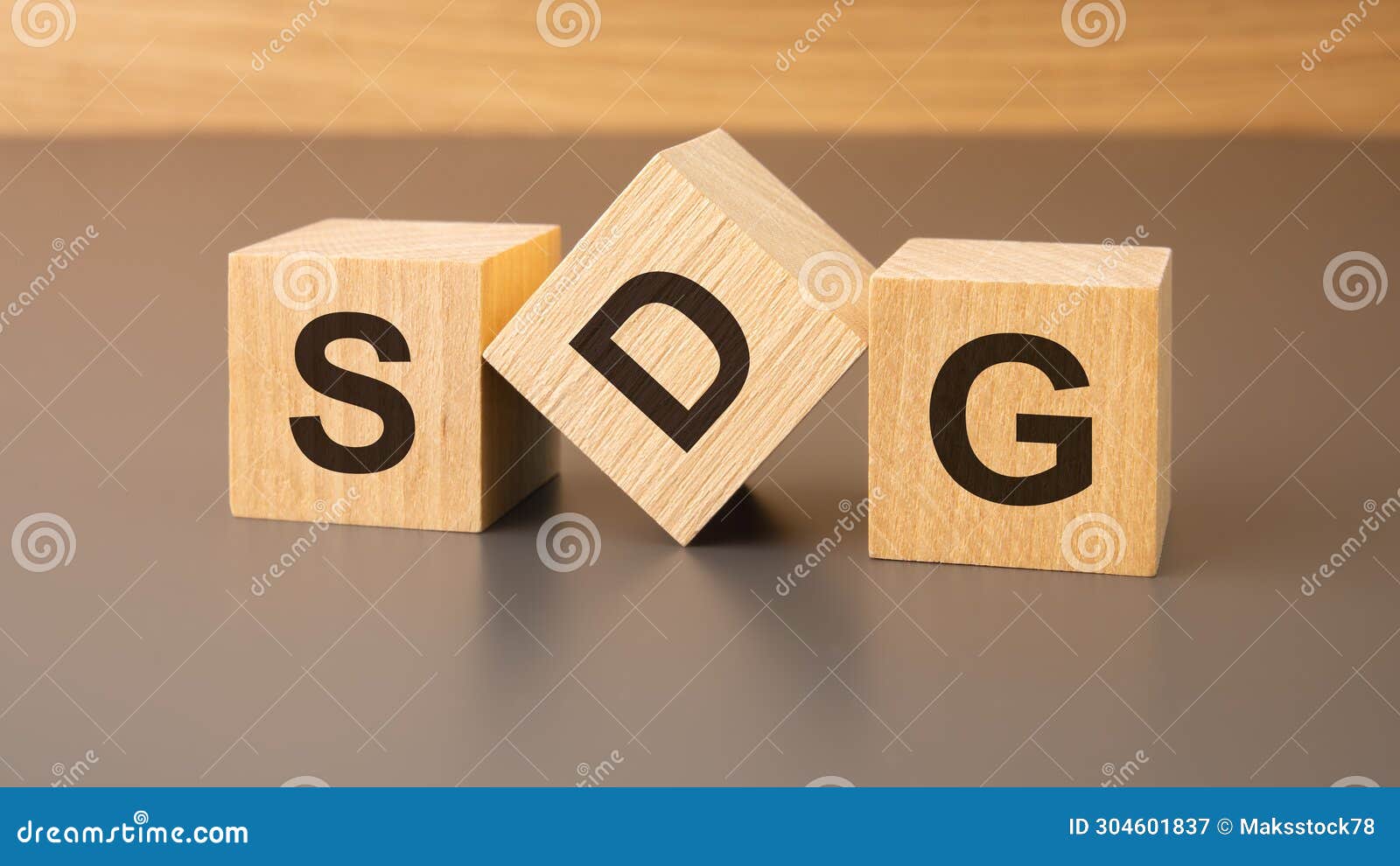 Three Wooden Blocks on a Brown Background, with the Abbreviation SDG ...
