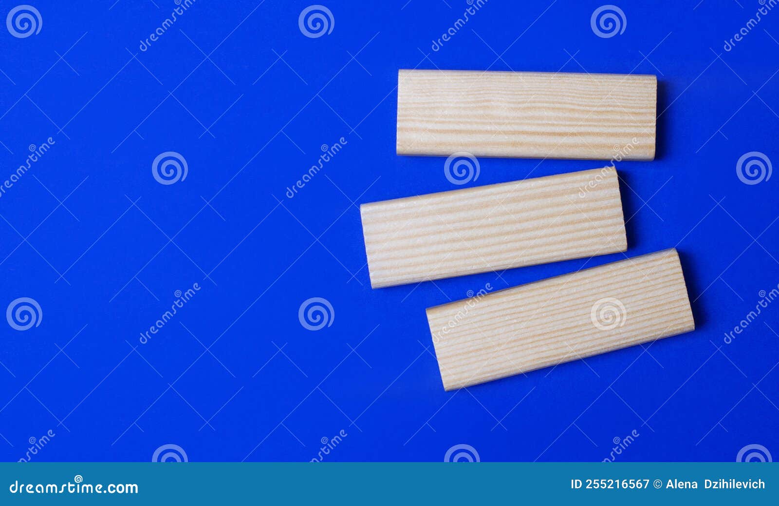 Three Wooden Blocks with Space To Insert Text on a Blue Background ...