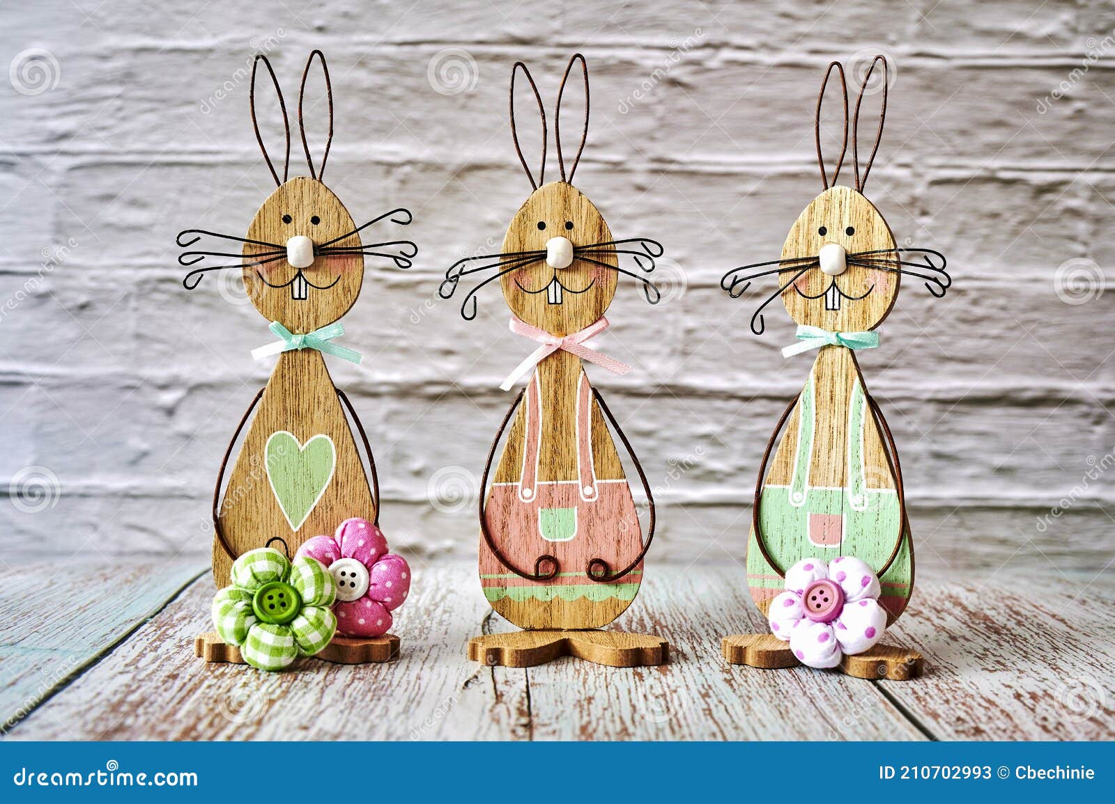 Three Wooden Easter Bunnies with Decoration Stock Image - Image of ...