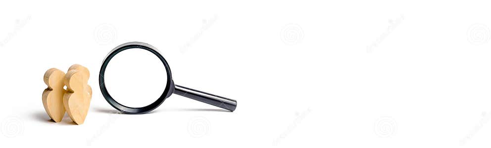 Three Wooden Human Figure Stands Near A Magnifying Glass On A White