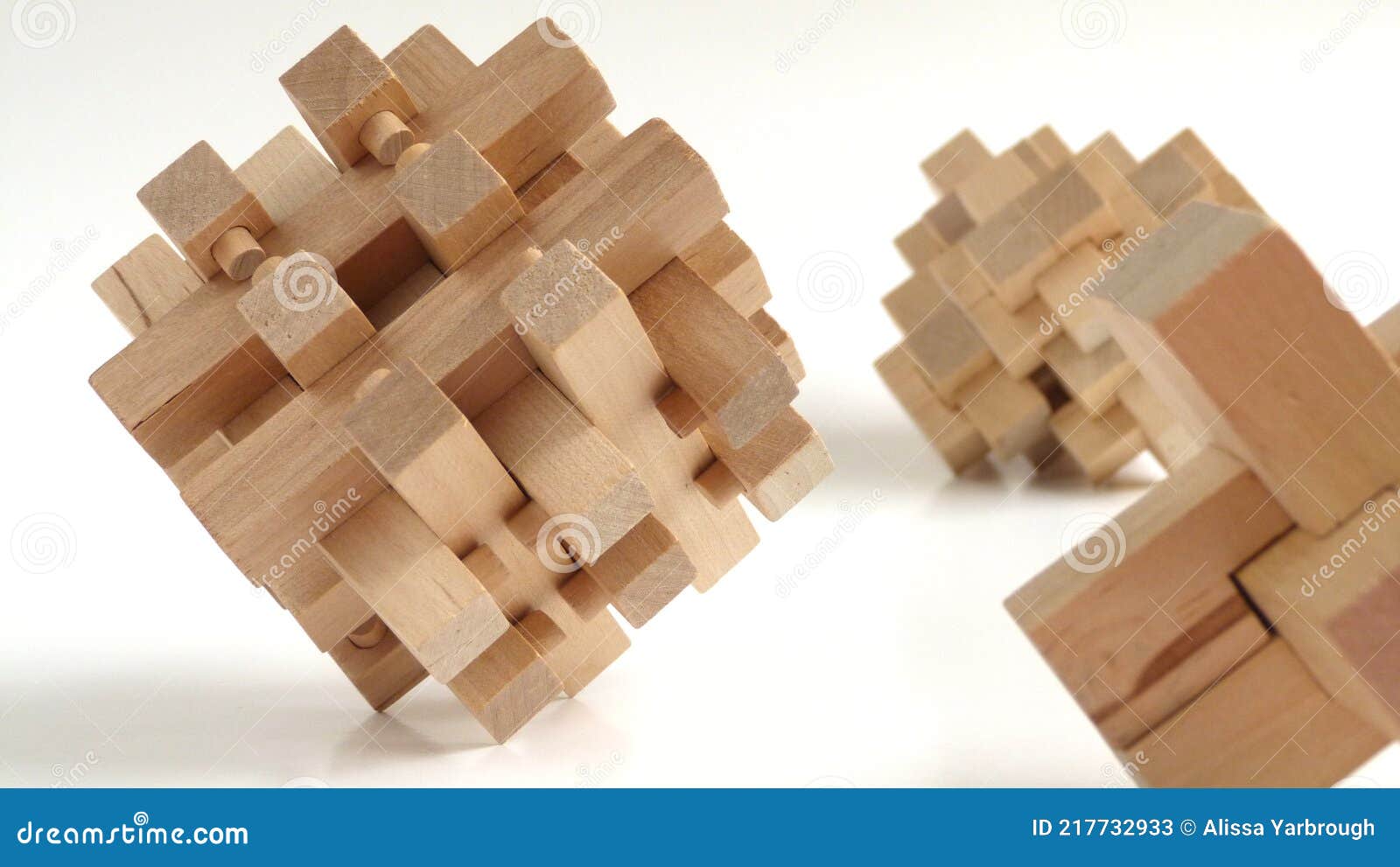 Three Wooden Interlocking Puzzles on a White Background Stock Image ...