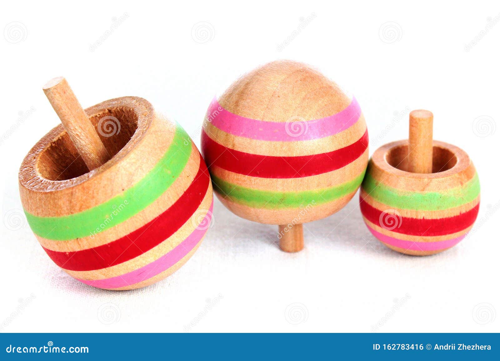 Three Wooden Tippe Tops on White Background Stock Photo - Image of ...