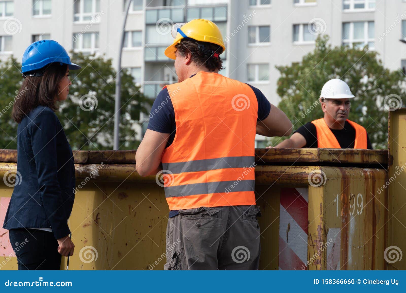 Three Workers on Construction Site Stock Photo - Image of outdoors ...