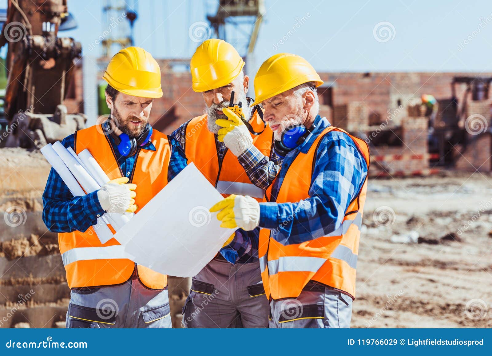 Three Workers Examining Building Plans Stock Image - Image of ...