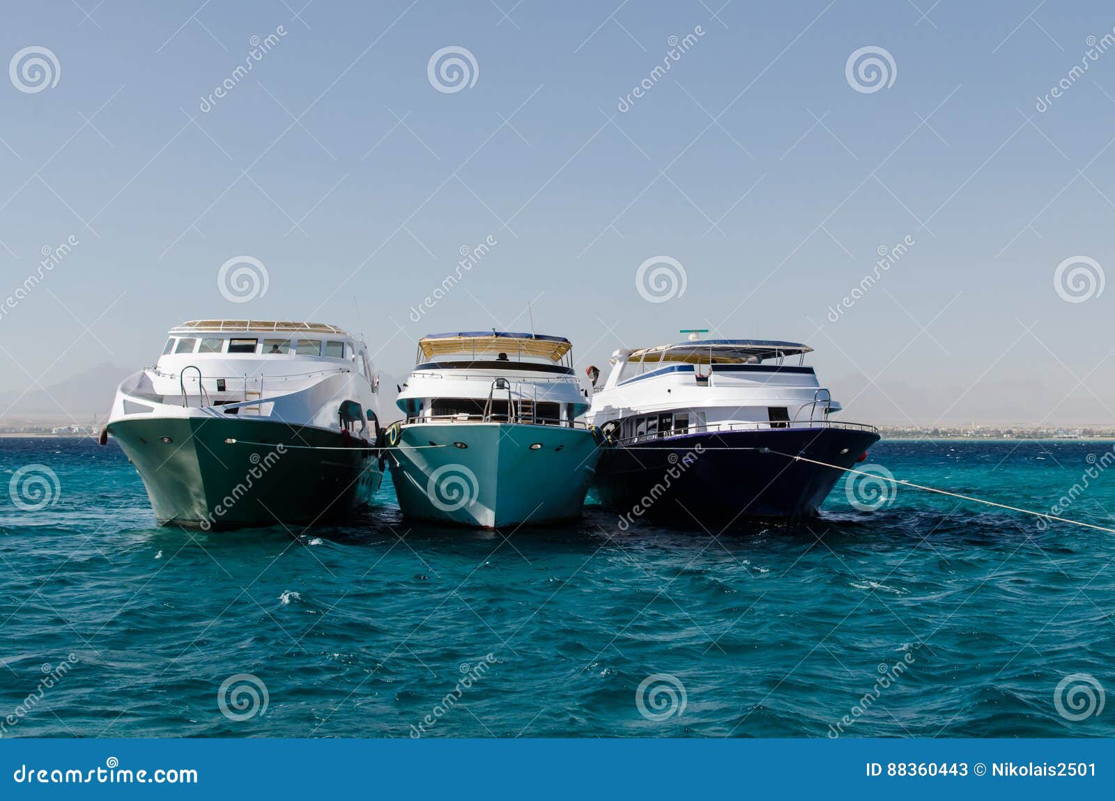 Three yachts in the sea stock image. Image of entertainment - 88360443