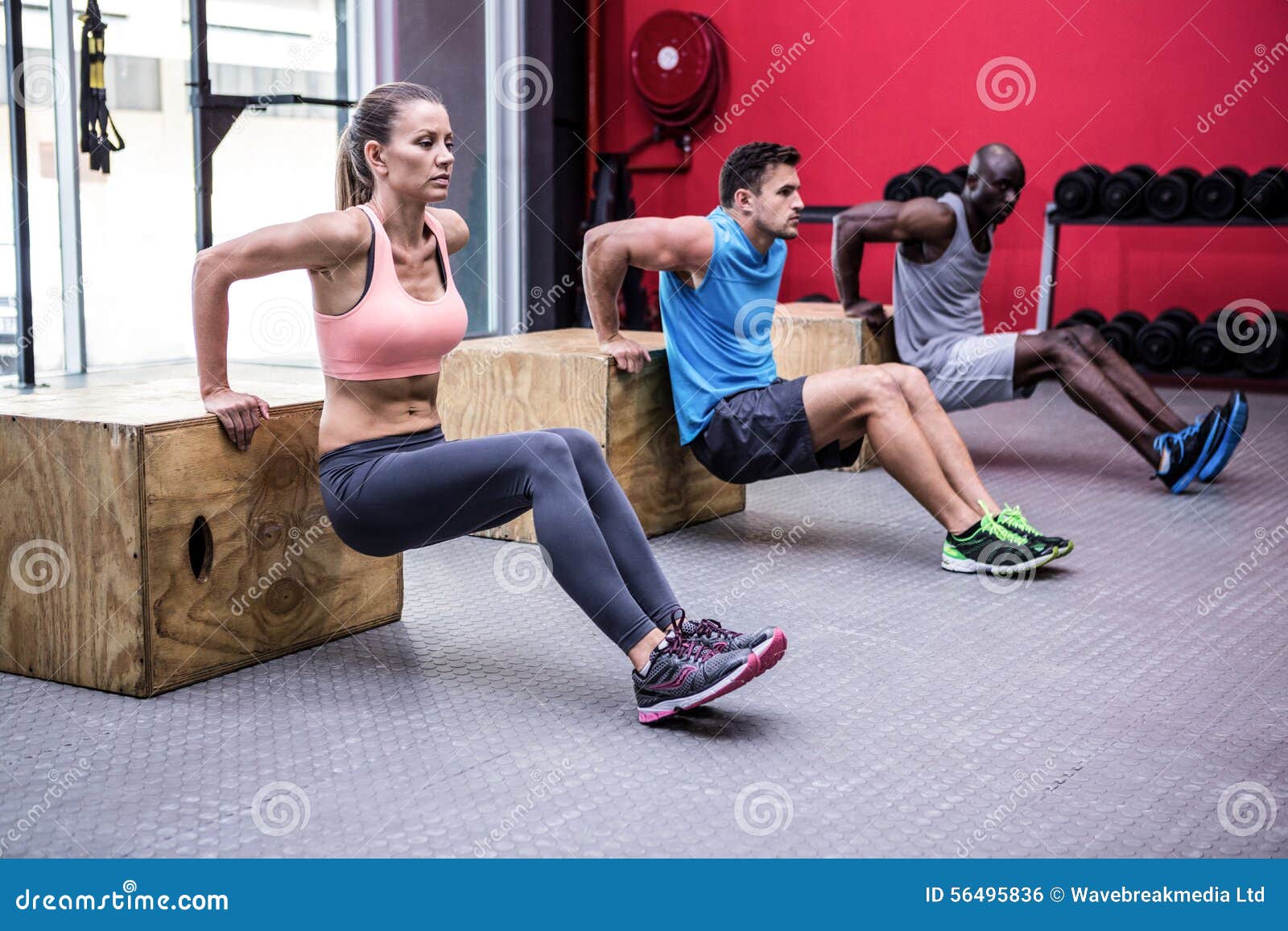 Three Young Bodybuilders Doing Exercises Stock Photo - Image of ...
