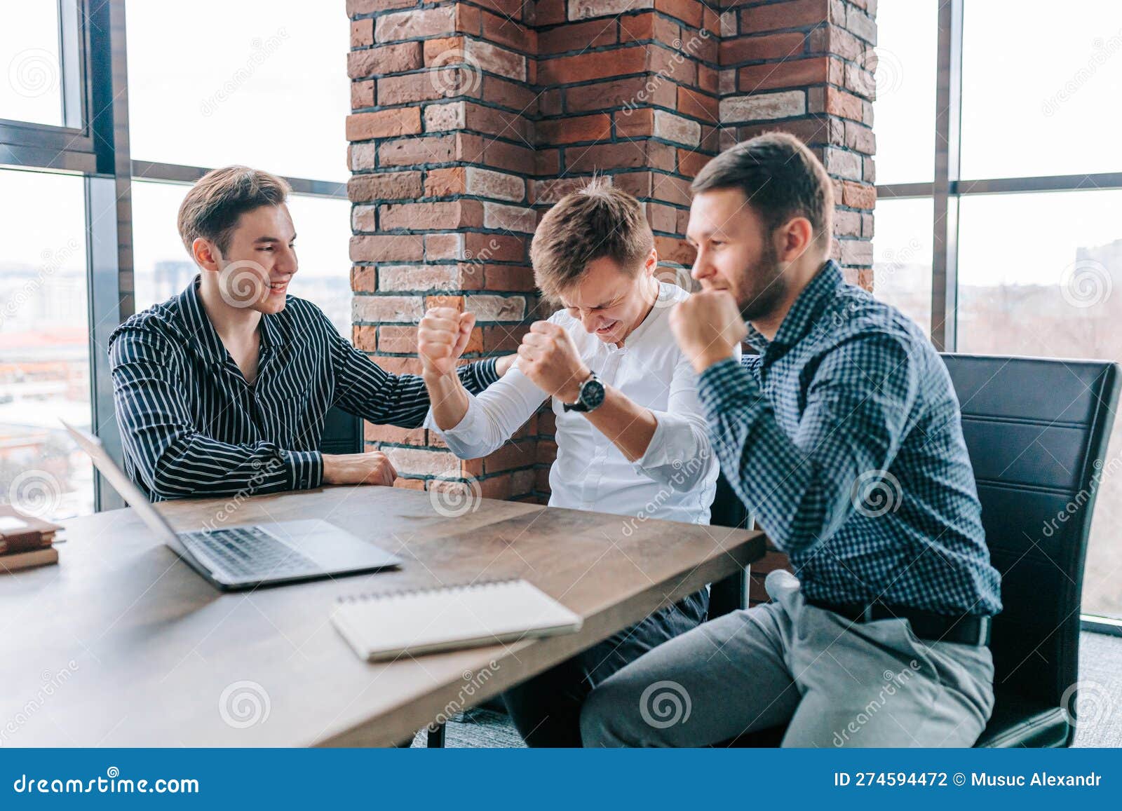 Joyful Colleagues Celebrating Their Successful Teamwork on a Laptop ...
