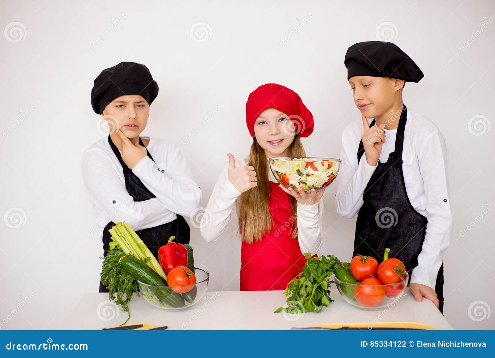 Three Young Chefs Evaluate a Salad Isolated Stock Photo - Image of ...