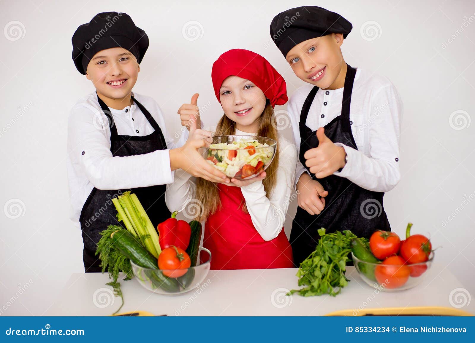 Three Young Chefs Evaluate a Salad Isolated Stock Photo - Image of girl ...