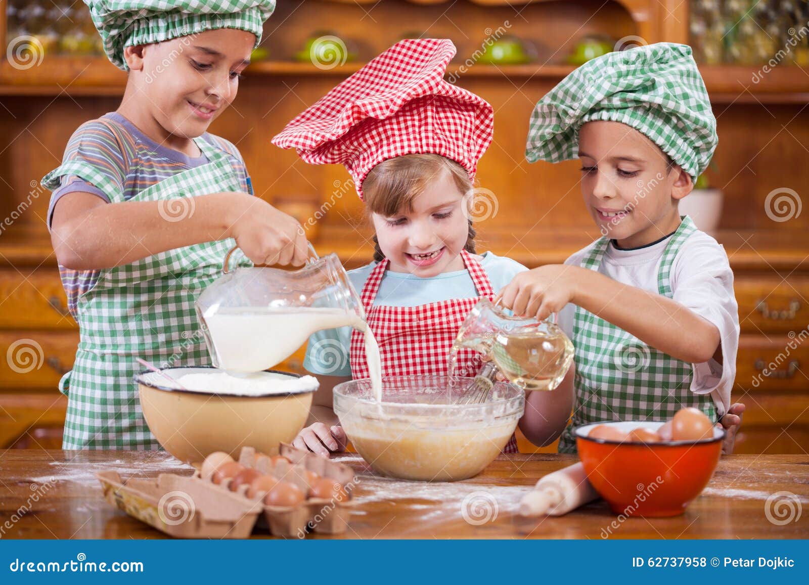 Three Young Children Make a Mess in the Kitchen Stock Photo - Image of ...