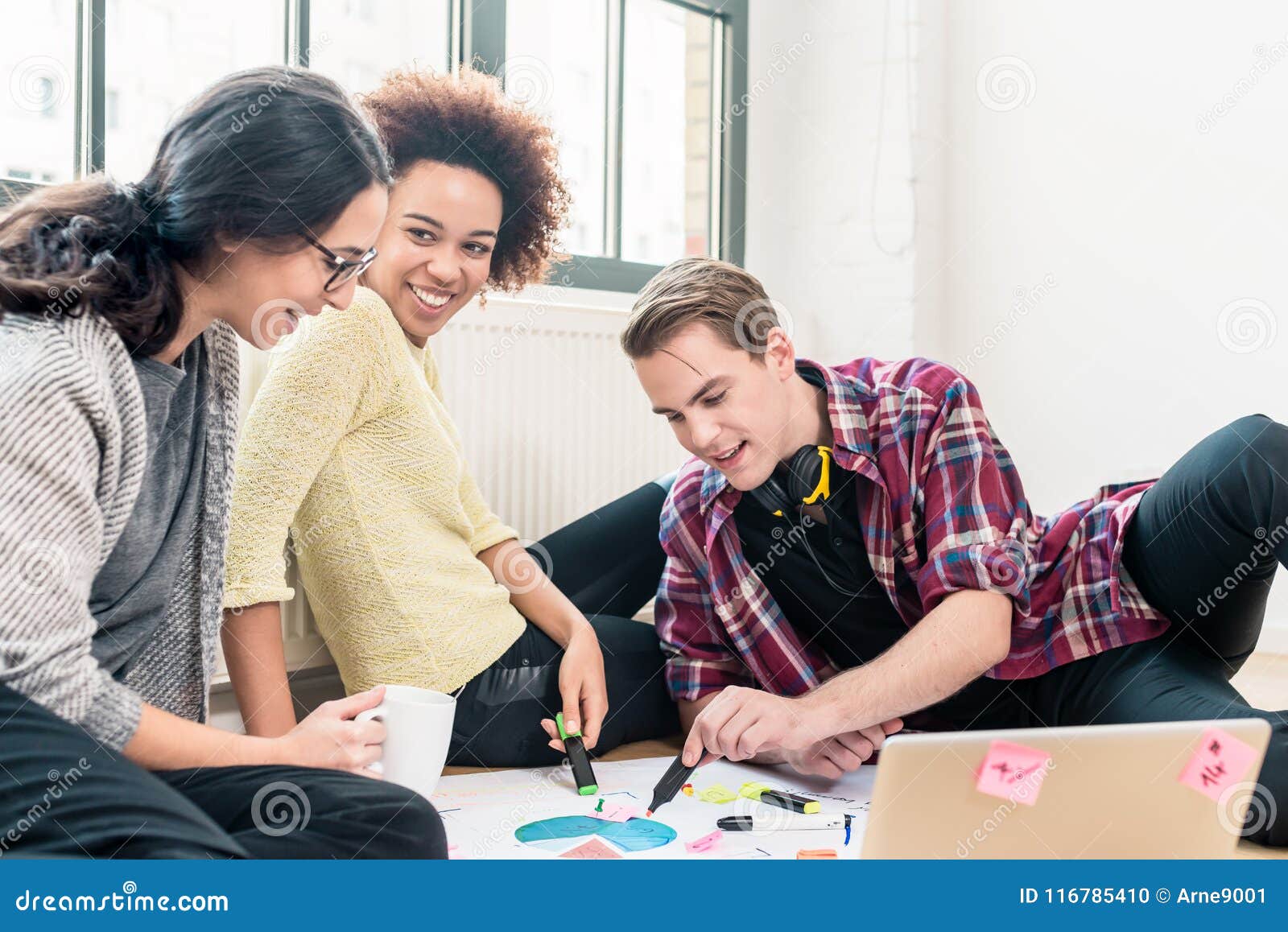 Three Young Creative Employees Working Together on a Project Stock ...