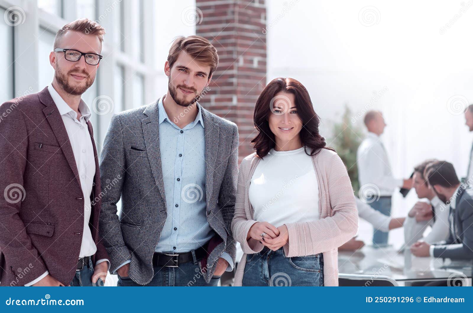 Three Young Employees Standing in a Modern Office Stock Photo - Image ...