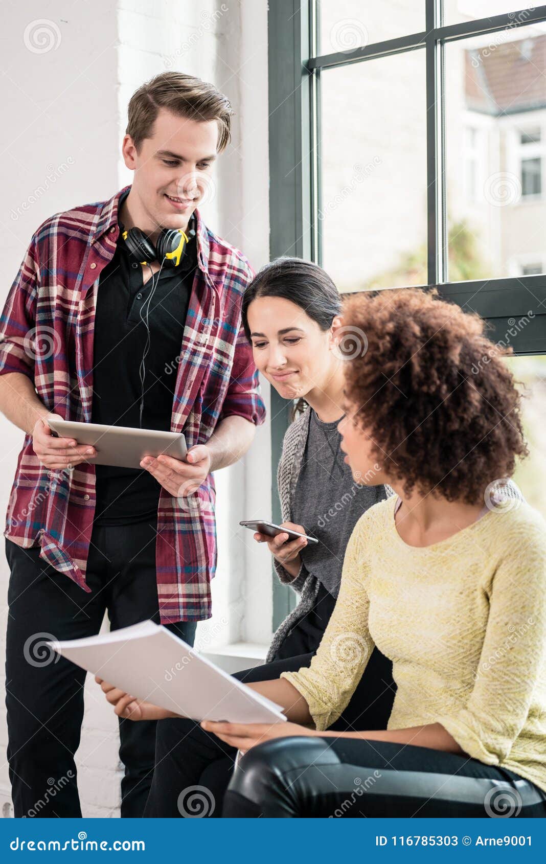 Three Young Employees Using Modern Devices during Break Stock Image ...