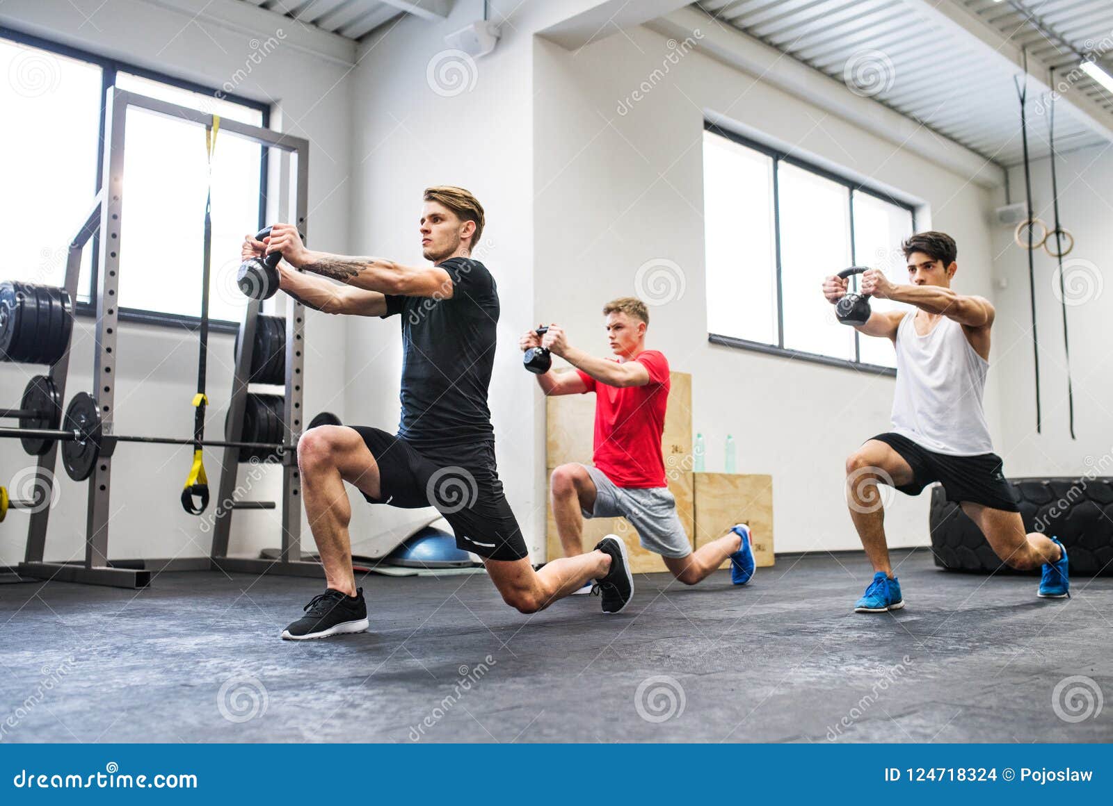 Three Young Men in Gym Doing Exercise with Kettlebells. Stock Photo - Image of strong, latino ...