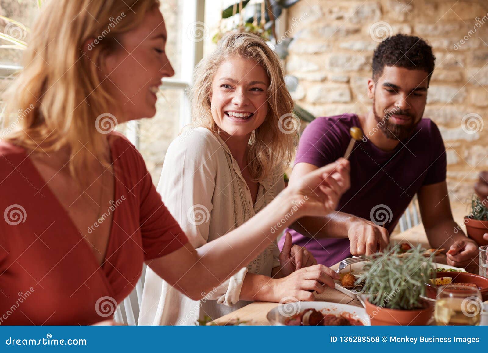 Three Young Friends Having Fun Eating Tapas at a Restaurant Stock Photo ...