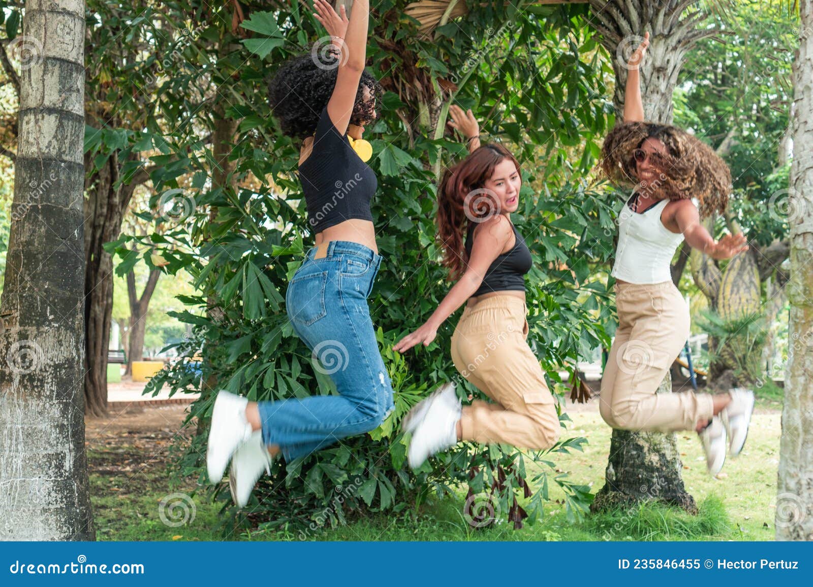 Three Young Friends Jumping in the Park Stock Image - Image of outside ...