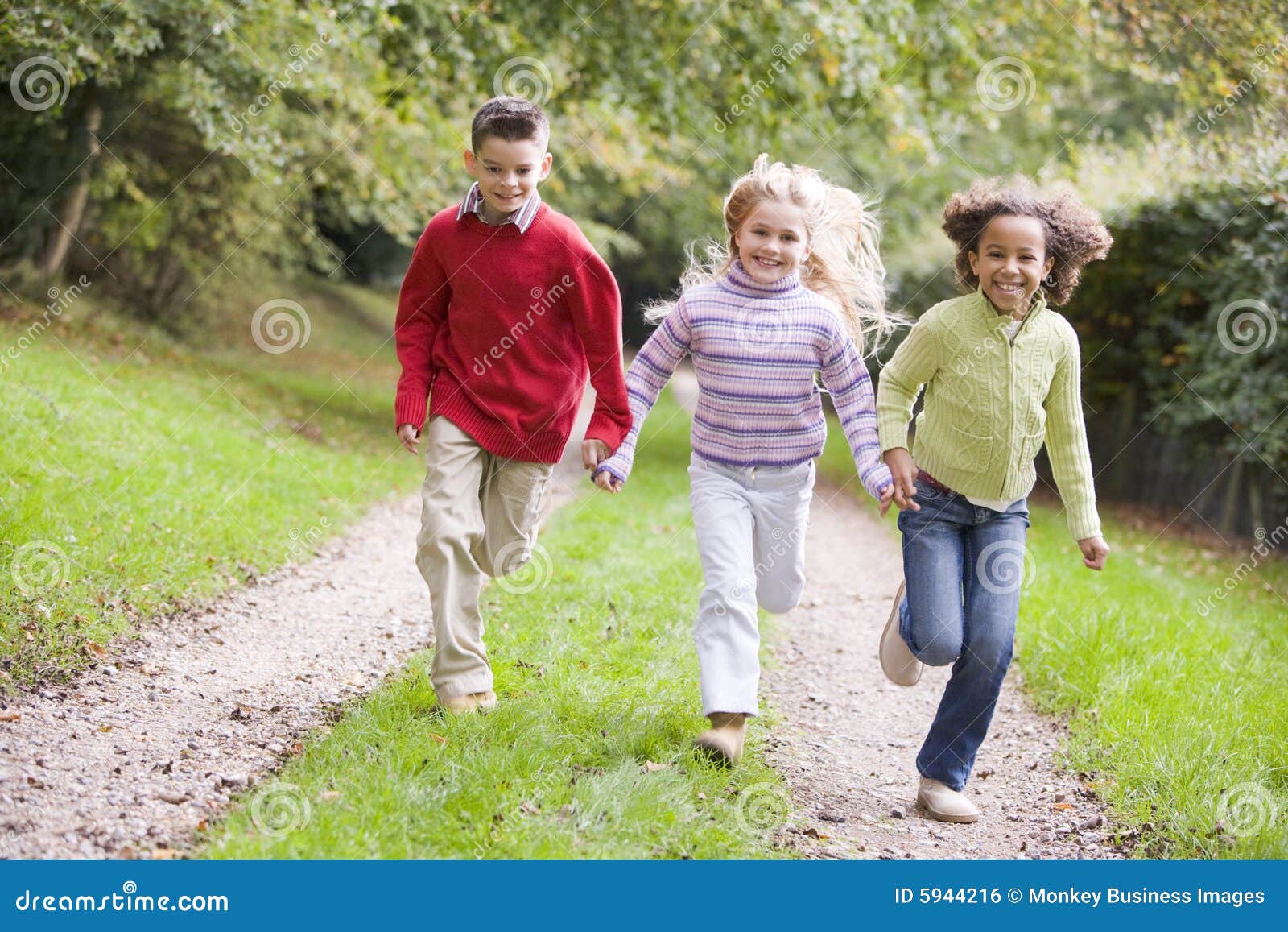 Three Young Friends Running on a Path Outdoors Stock Photo - Image of ...
