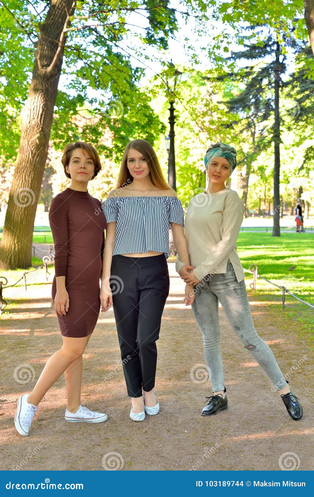Three Young Girls Stand in the Park Stock Photo - Image of sunny ...