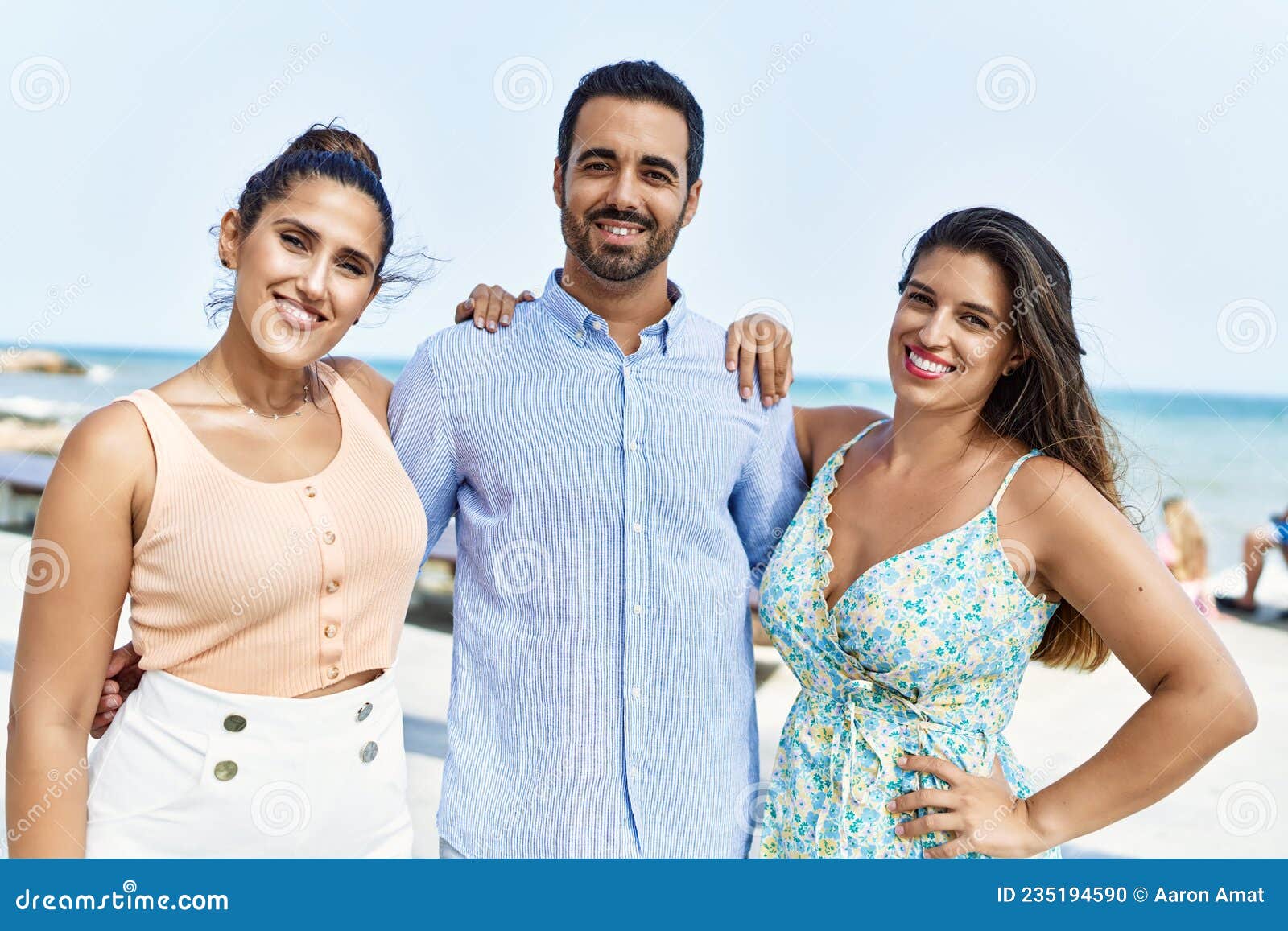 Three Young Hispanic Friends Smiling Happy and Hugging at the Beach ...