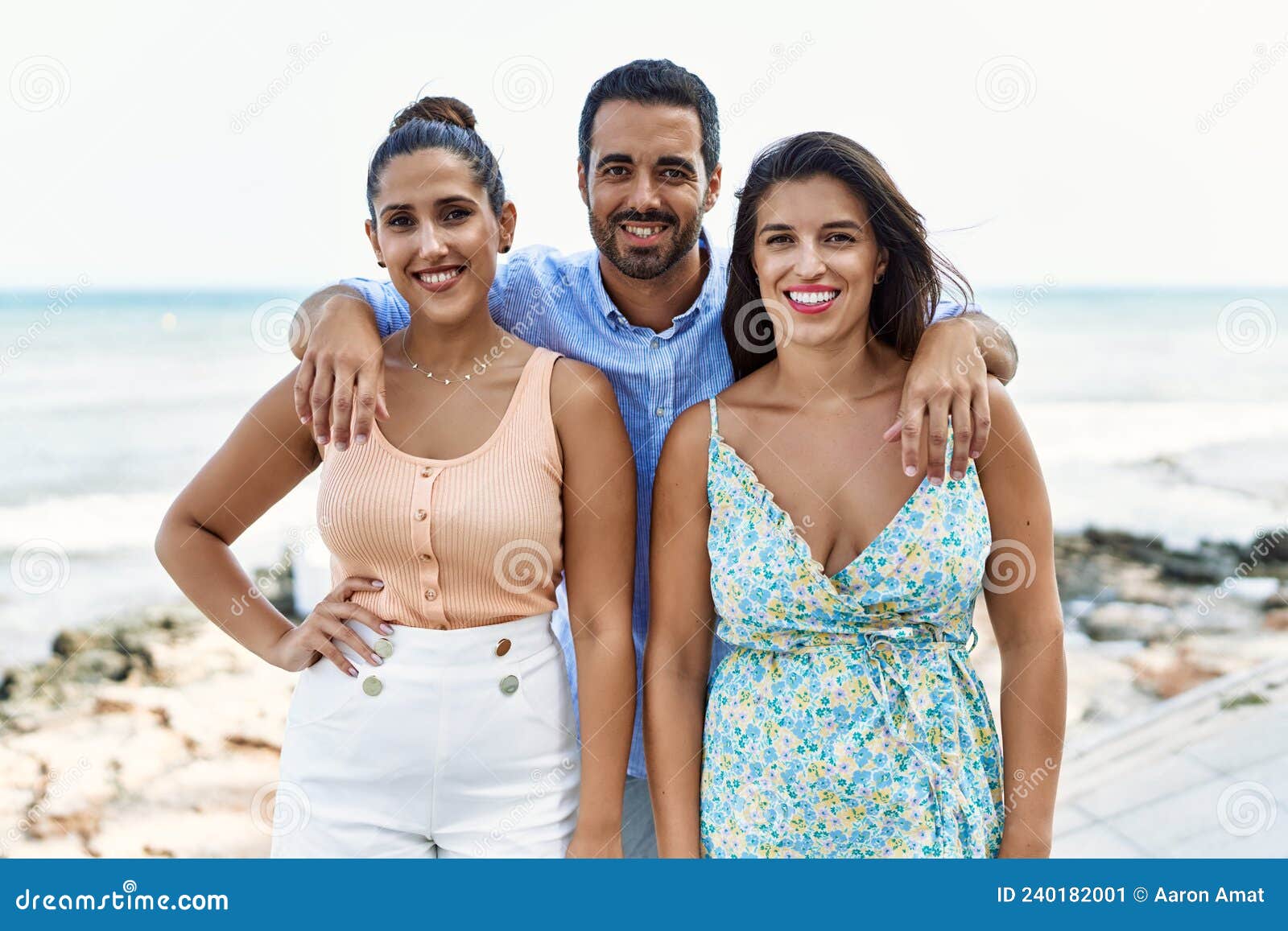 Three Young Hispanic Friends Smiling Happy and Hugging at the Beach ...