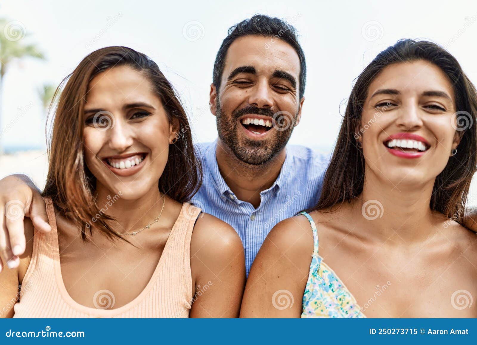 Three Young Hispanic Friends Smiling Happy and Hugging at the Beach ...