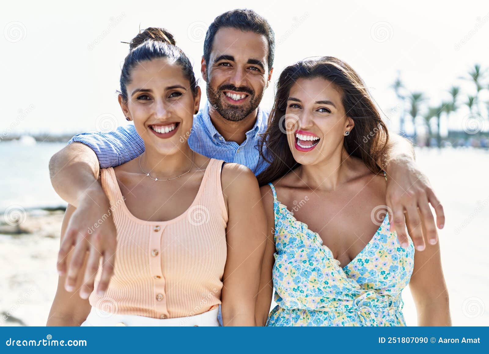 Three Young Hispanic Friends Smiling Happy and Hugging at the Beach ...