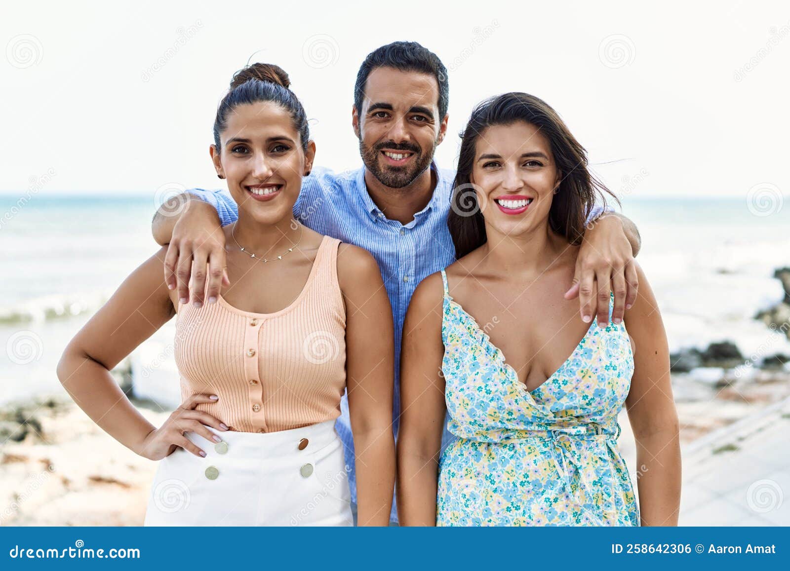 Three Young Hispanic Friends Smiling Happy and Hugging at the Beach ...