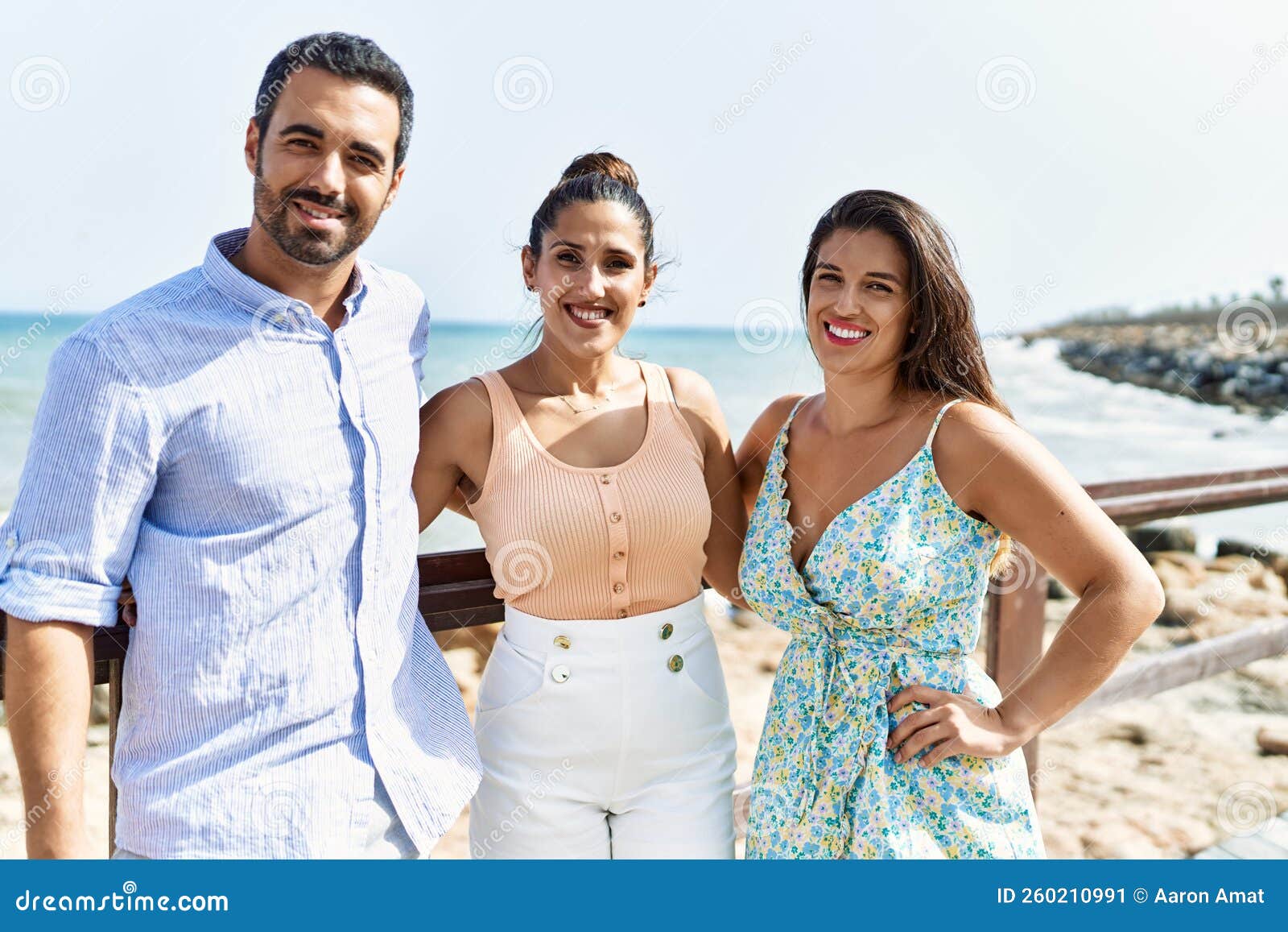 Three Young Hispanic Friends Smiling Happy and Hugging at the Beach ...
