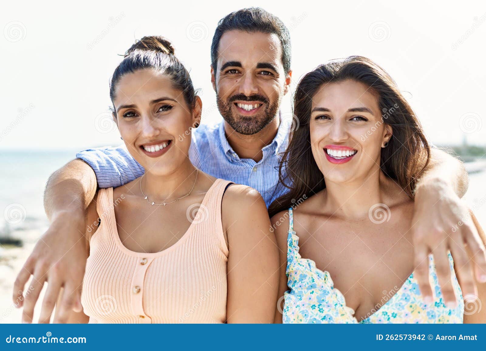 Three Young Hispanic Friends Smiling Happy and Hugging at the Beach ...