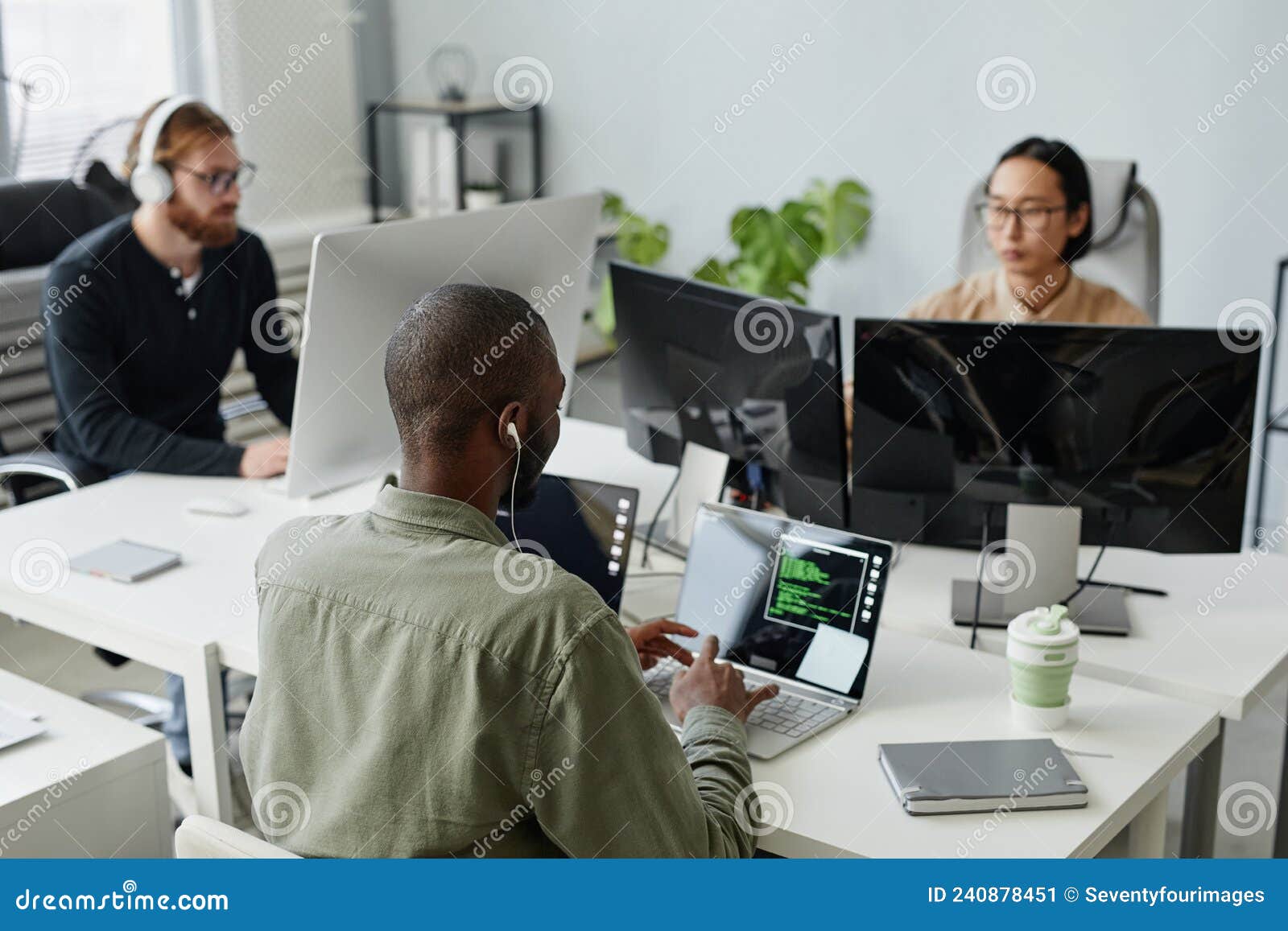 Three Young Intercultural Diversity Programmers Sitting by Computers ... Three Young Intercultural Diversity Programmers Sitting by Computers ...