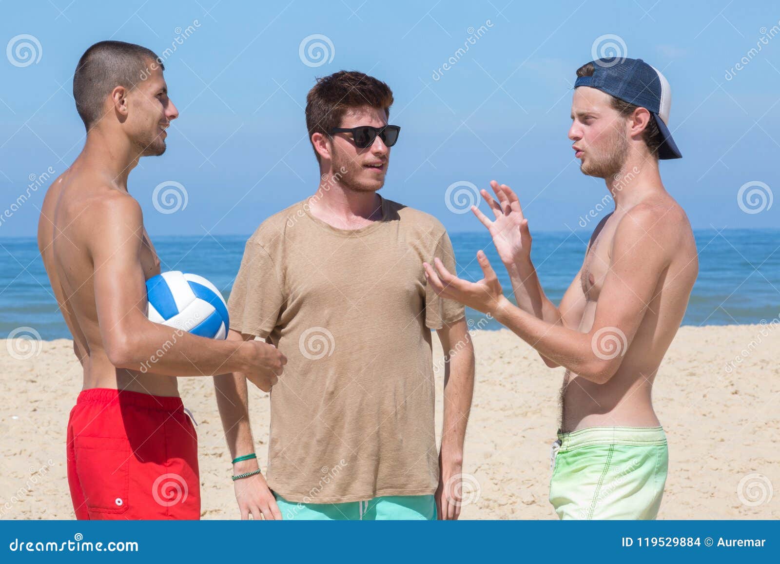 Three young men on beach stock photo. Image of casual - 119529884